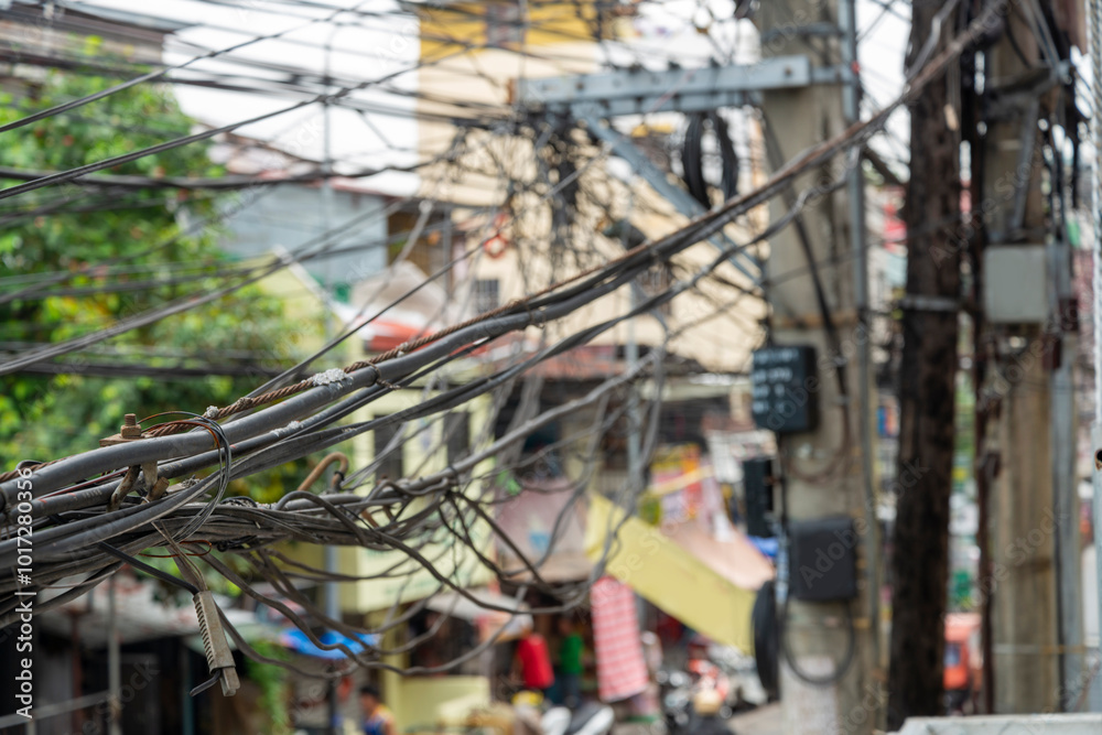 Poster Tangled mess of eletrical cables,outdoors and above the streets ...
