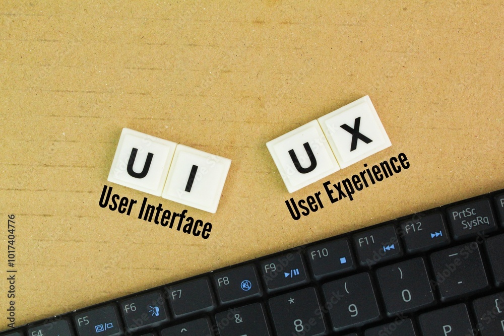 laptop keyboard and wooden blocks with the letters UX and UI. User ...