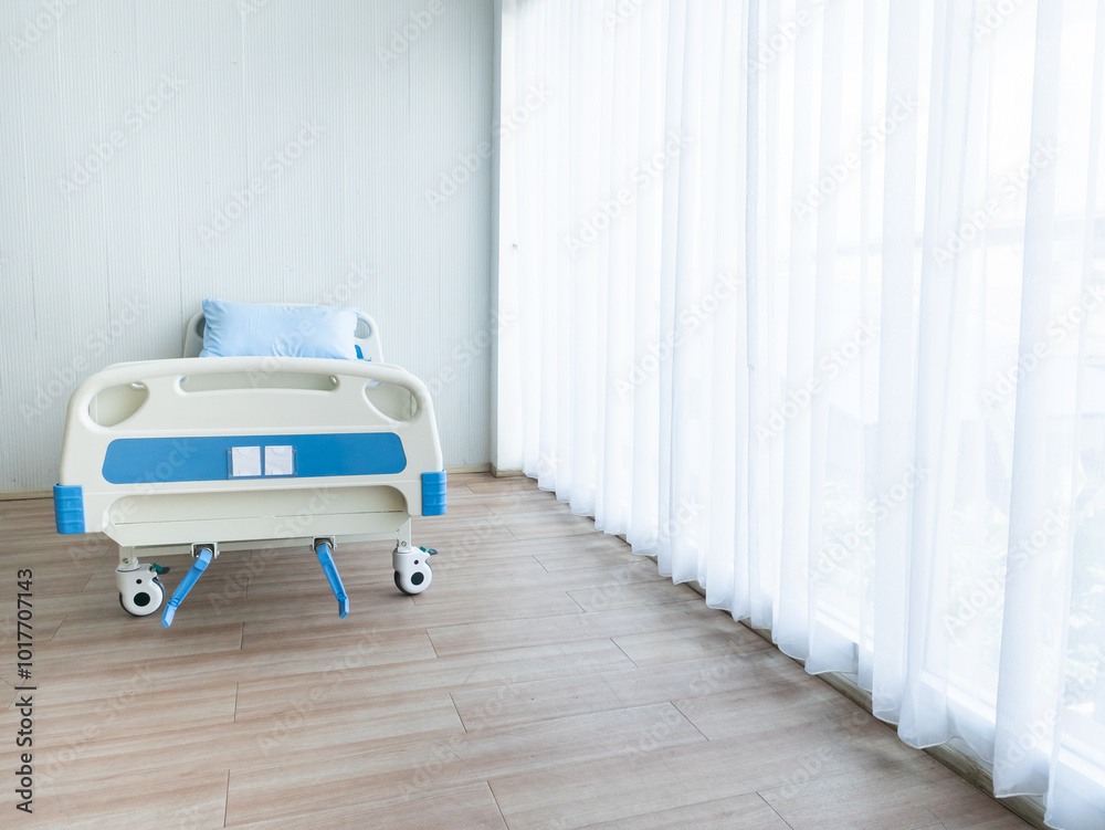 Adjustable hospital bed with blue accents in a minimalist hospital room ...