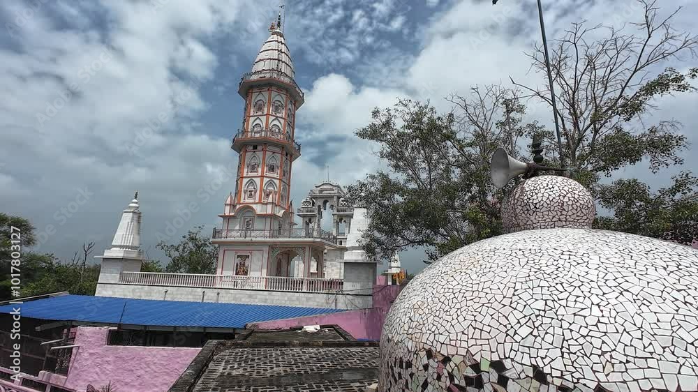 Exterior view of a Hindu temple with a towering structure against a ...