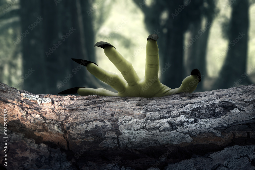 Witch hand with long nail claw reaching out from a wooden log. Scene is ...