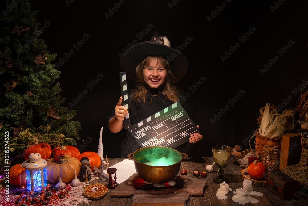 Halloween, smiling little cute girl with Film Clapperboard, dressed as ...