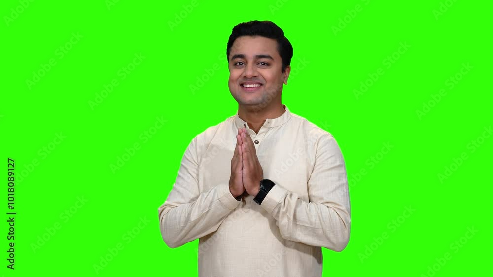 Green screen young smart man. It is a festive time. Folding hands to ...
