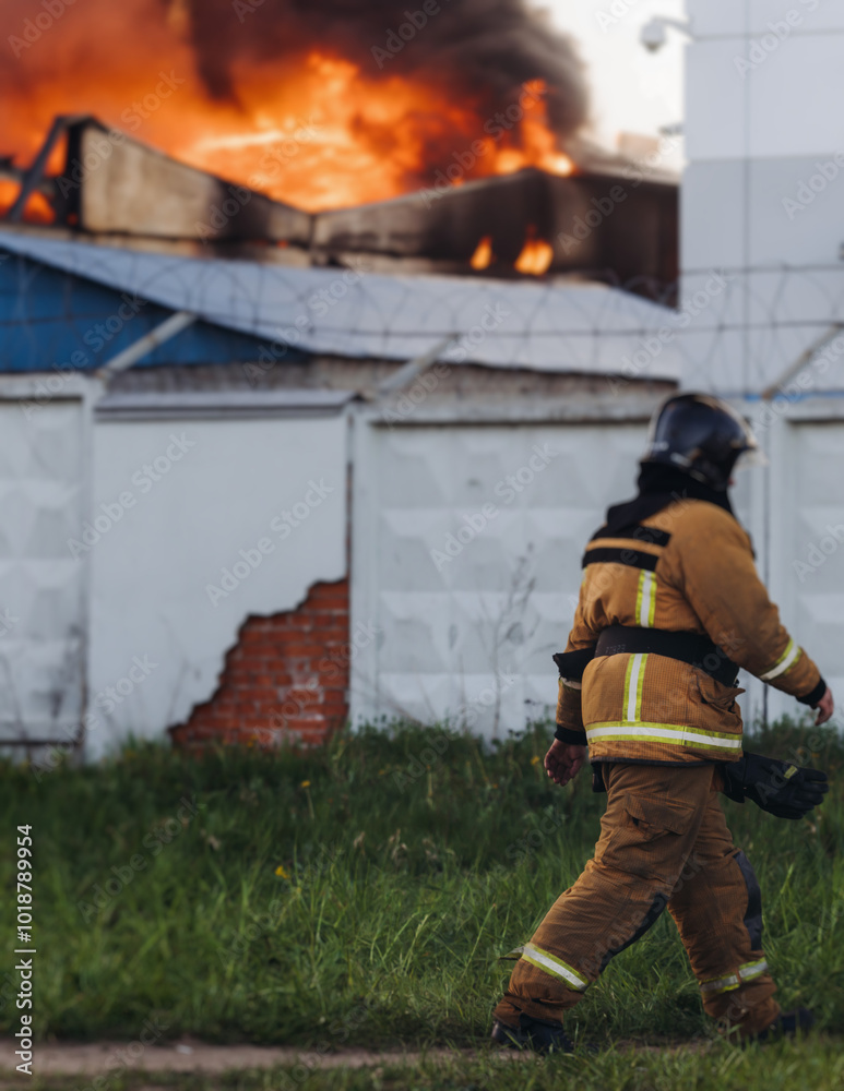 Group of fire men in uniform during fire fighting operation in the city ...