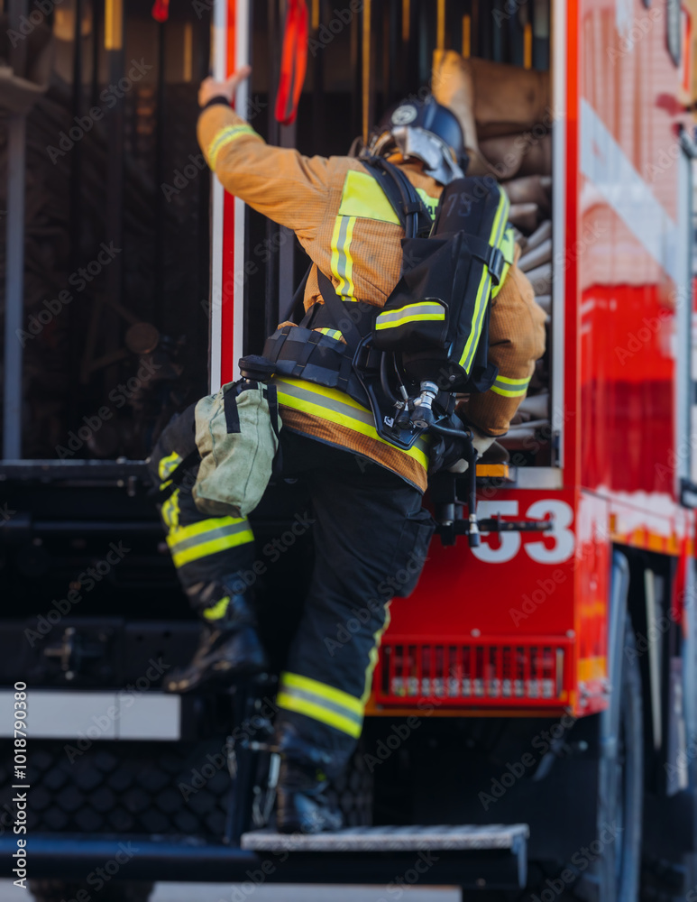 Group of fire men in uniform during fire fighting operation in the city ...