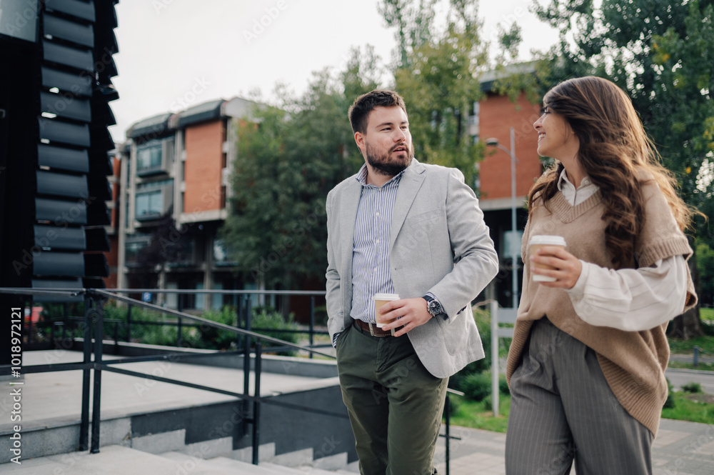 Business people having informal meeting while walking outdoors and ...