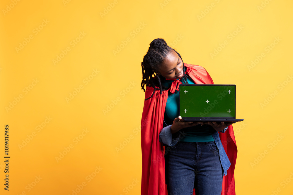 African american girl wearing superhero costume for Halloween, looking ...