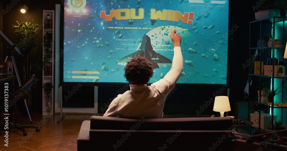 Gamer receiving winner screen on TV after killing all enemies and ...