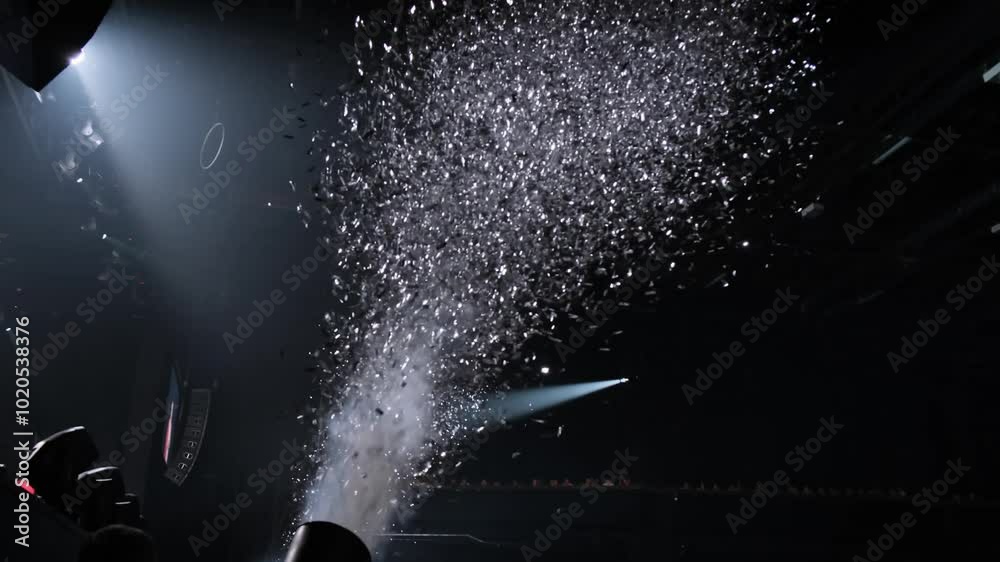 Confetti cannon begins to scatter mono colored silver glitter ...