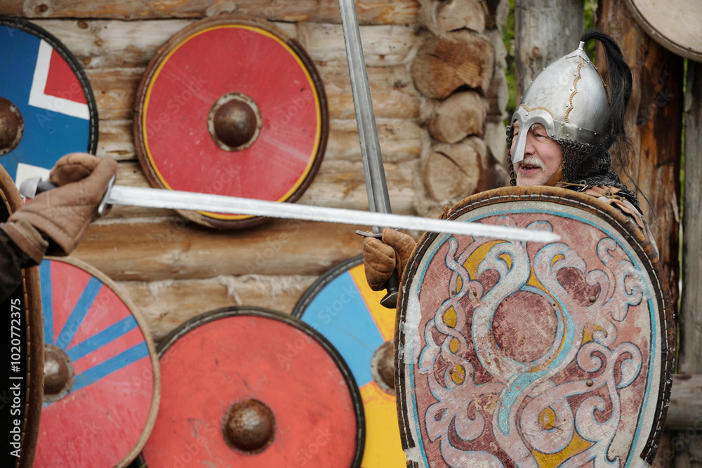 Viking re-enactors engaging in battle with detailed shields and armor ...