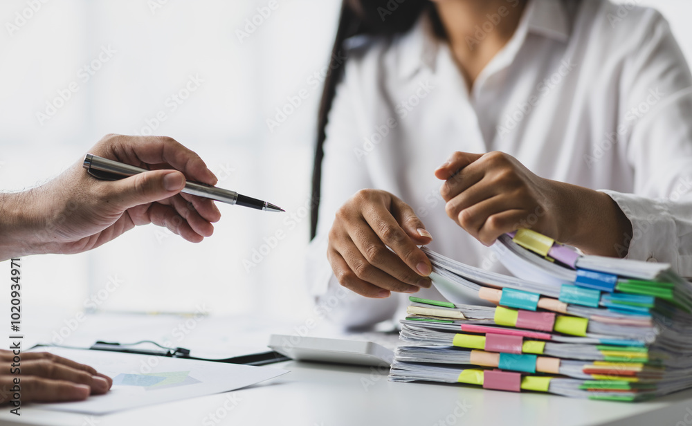 Businesswoman working in piles of unfinished documents on desk office ...