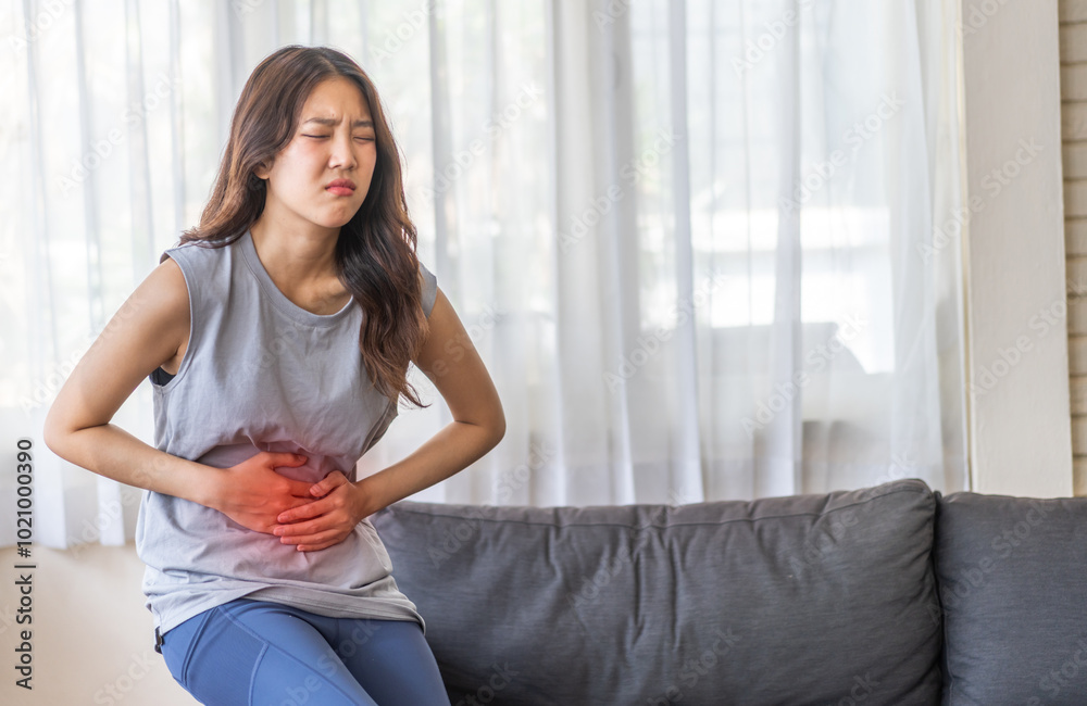 Young woman experiencing abdominal pain, uterus pain, reproductive ...