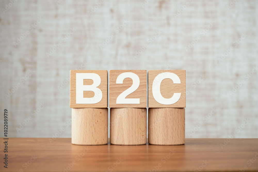 There is wood cube with the word B2C. It is an abbreviation for B2C as ...