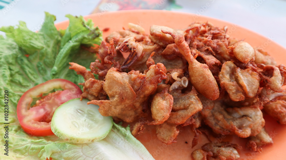 Indonesian traditional food named "cumi goreng tepung" i.e. slices of ...