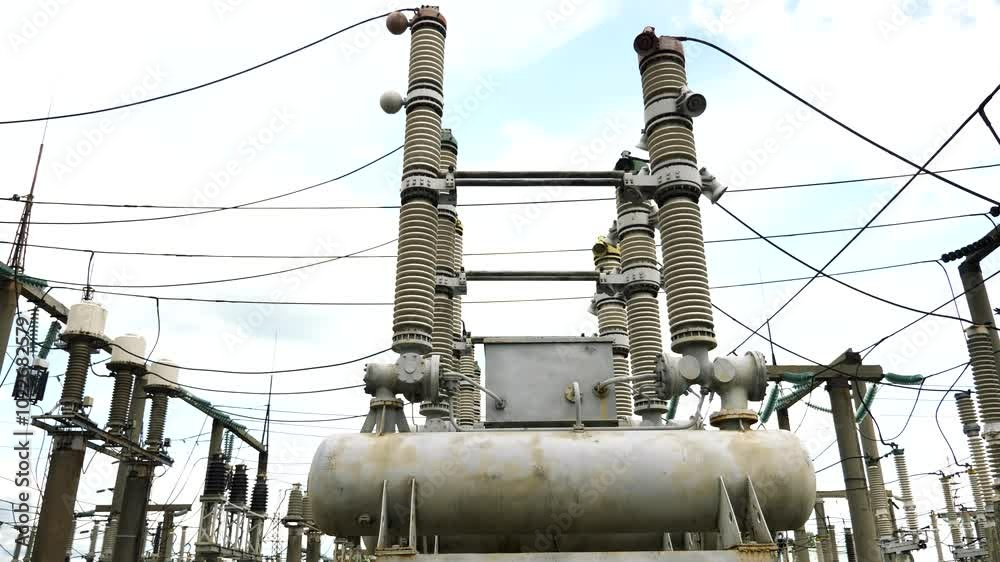High voltage electrical substation. Power plant with high poles and ...