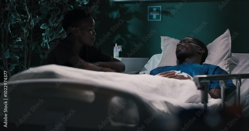 Caring girlfriend chats with her African partner in the hospital ...
