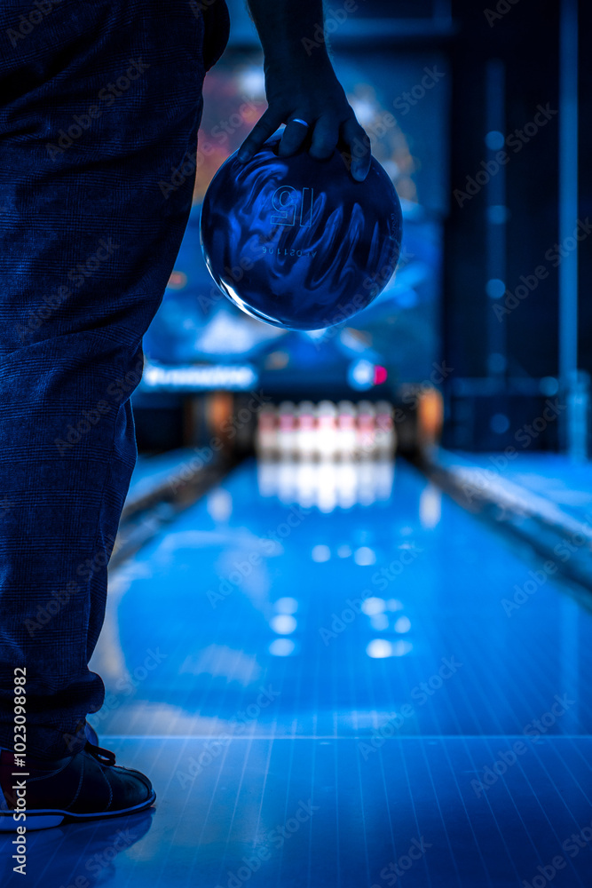 This photo shows a bowler getting ready to throw a strike. The blue ...