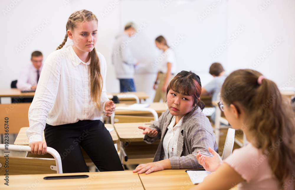 Three teenage girls talking and having fun, spending time together ...