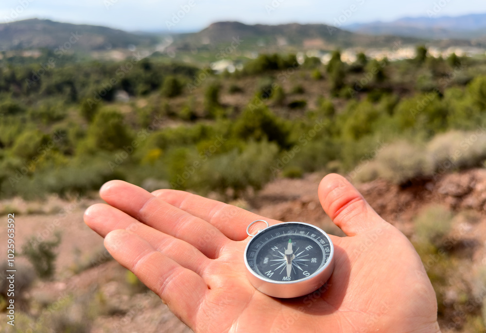 Compass in hand in mountains during Hiking. Tourist compass for ...