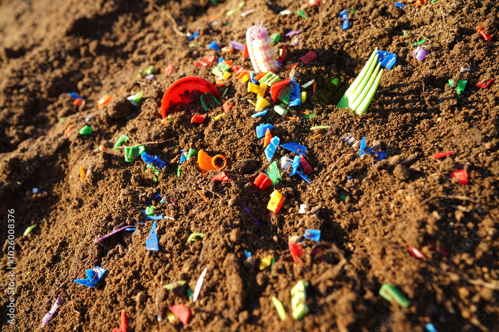 Microplastic pollution. Microplastics in ground. Soil contaminated with ...