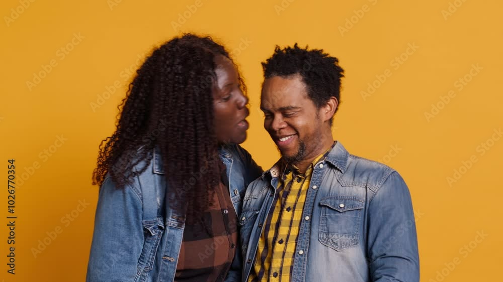 Funny wife making her husband laugh about sweet nothings, whispering ...