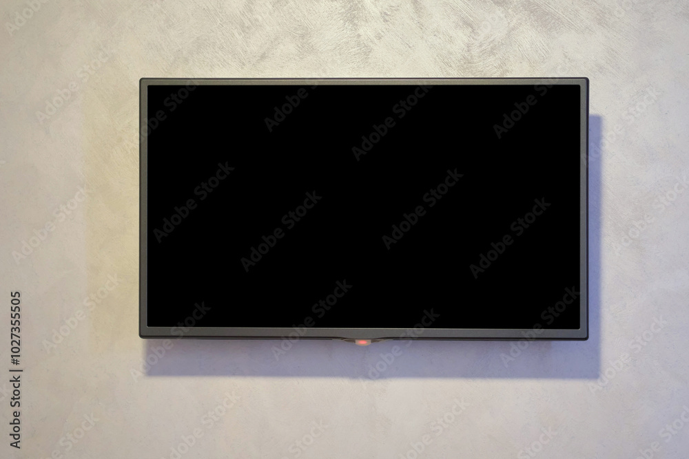Black TV screen hanging on the wall. Rectangular television on the wall ...
