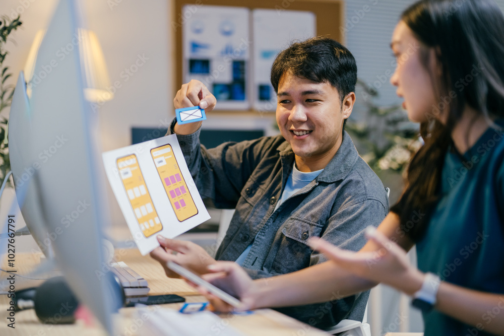 Asian Ui Ux Designers Discussing Mobile App Design In Modern Office Brainstorming Planning