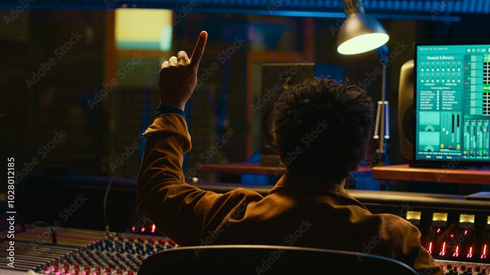 African american audio engineer counting down singer in sound booth ...
