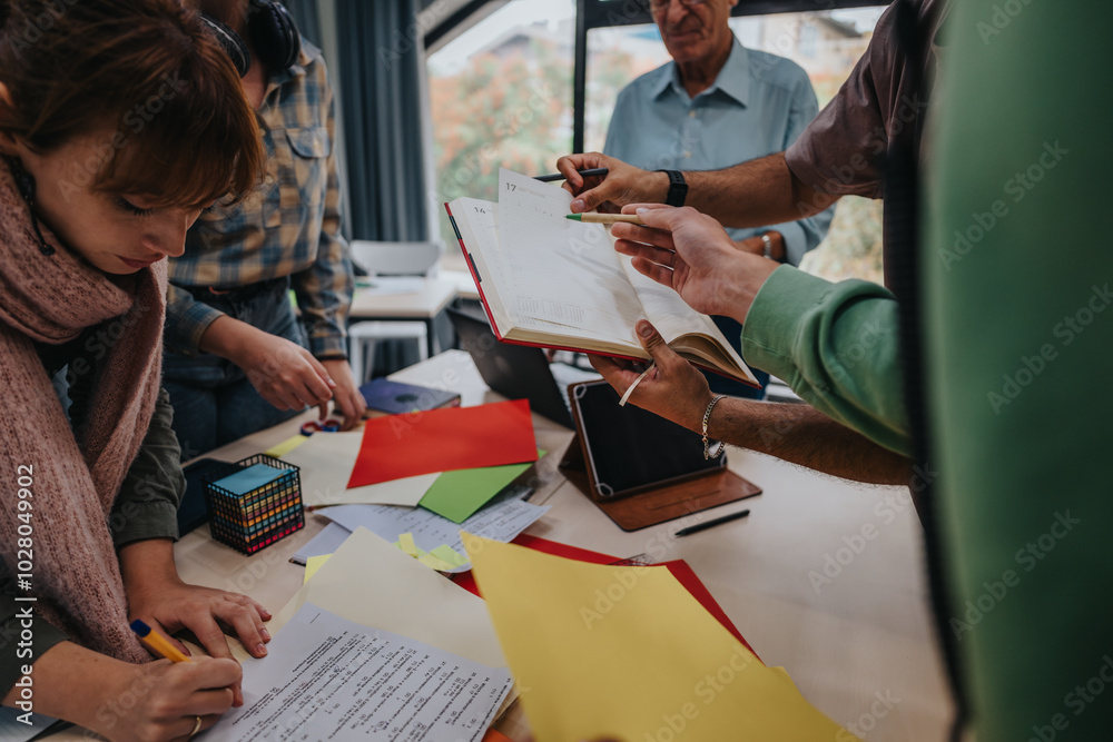 A group of diverse college students work together on a project in a ...