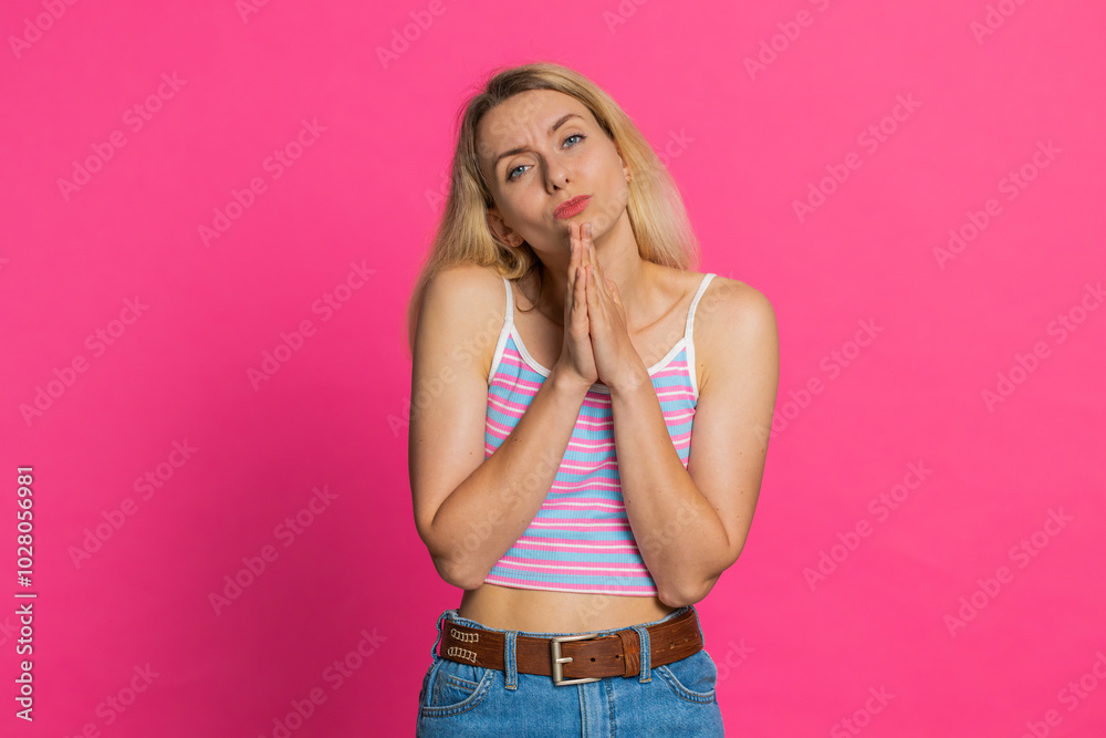 Please, God help. Caucasian young woman in crop top praying, looking at ...