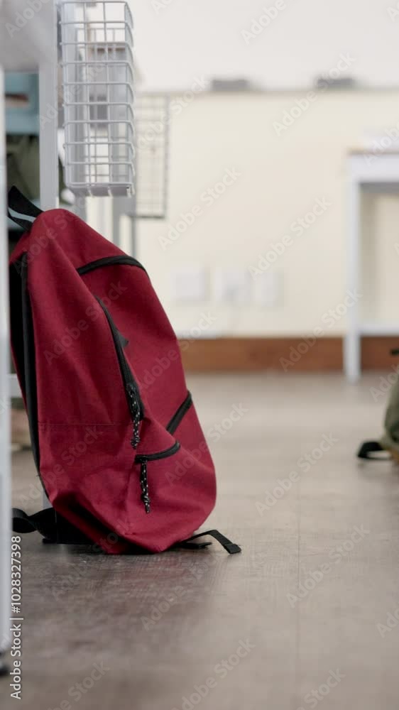 Backpack, floor and desks in empty classroom at school for lesson ...