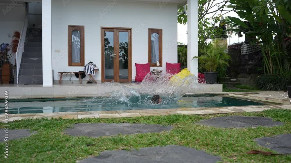 A girl jump to pool in beautiful backyard her house. Woman have have a ...