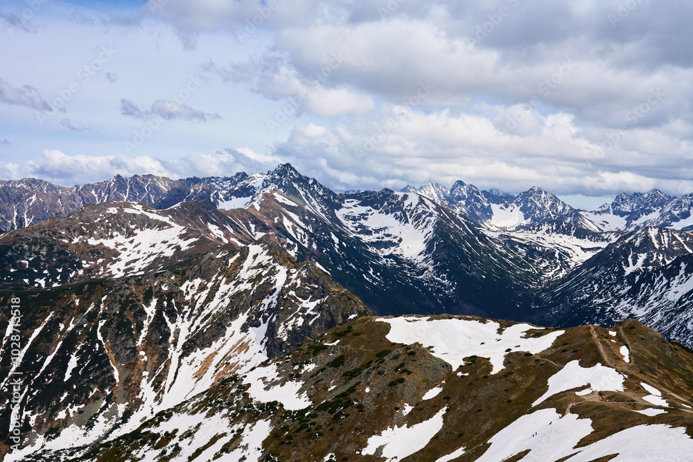 Panoramic view of snow-capped mountain range against cloudy sky. Tatra ...