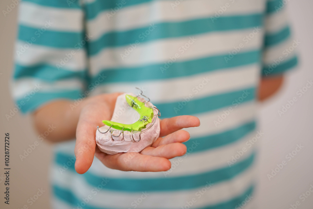 Dentist test setting of palatal braces for young patient in child's ...