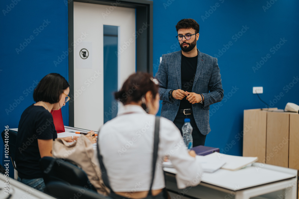 Students are engaged in their tasks while a professor provides guidance ...