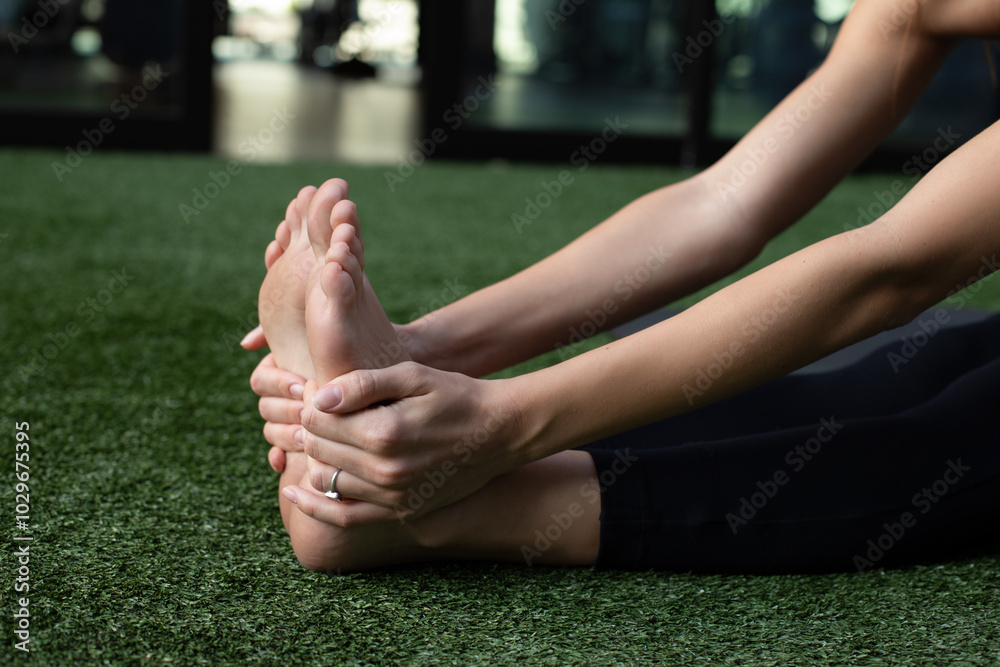 Stretched feet, woman clasping feet with hands, stretching, flexibility ...
