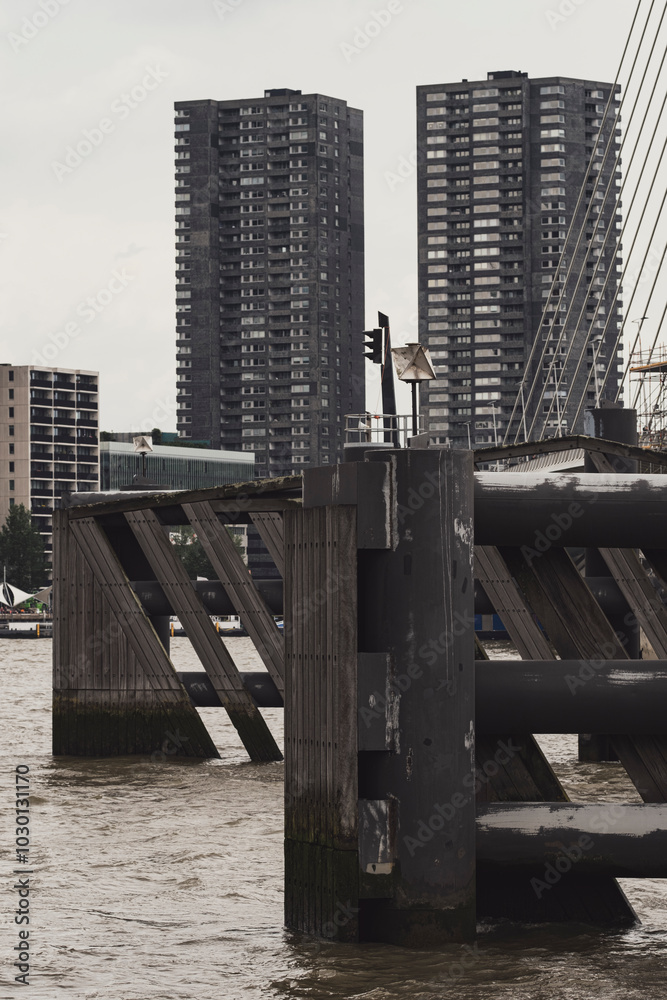 The image depicts towering modern skyscrapers alongside an industrial ...
