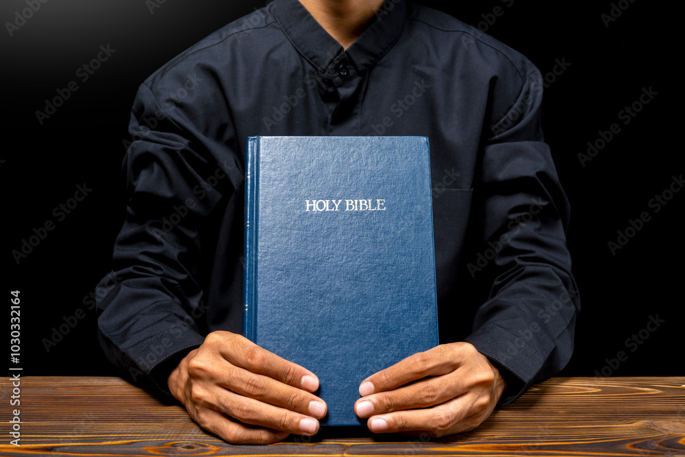 Man holding a holy bible in his hand. Symbol of faith and worship in ...