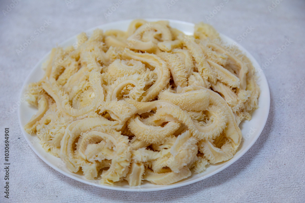 Beef tripe (bucho), beef stomach, tripe on a white plate. Dobradinha ...