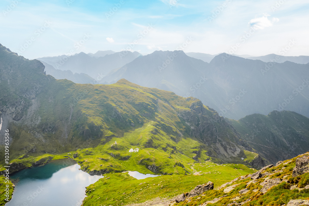 Hiking in Fagaras mountains on Iezerul Caprei peak over Transfagarasan ...