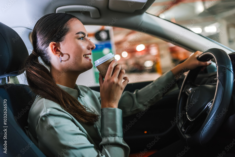 Young woman searching for parking spot in underground garage. Driving ...