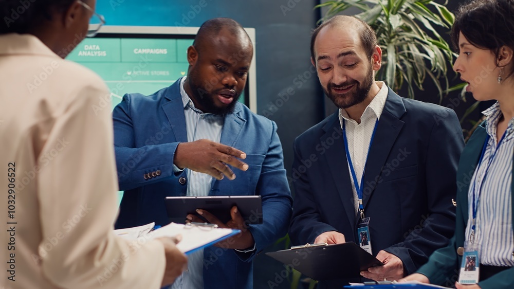 Supervisor and employees attend a status update meeting with their ...