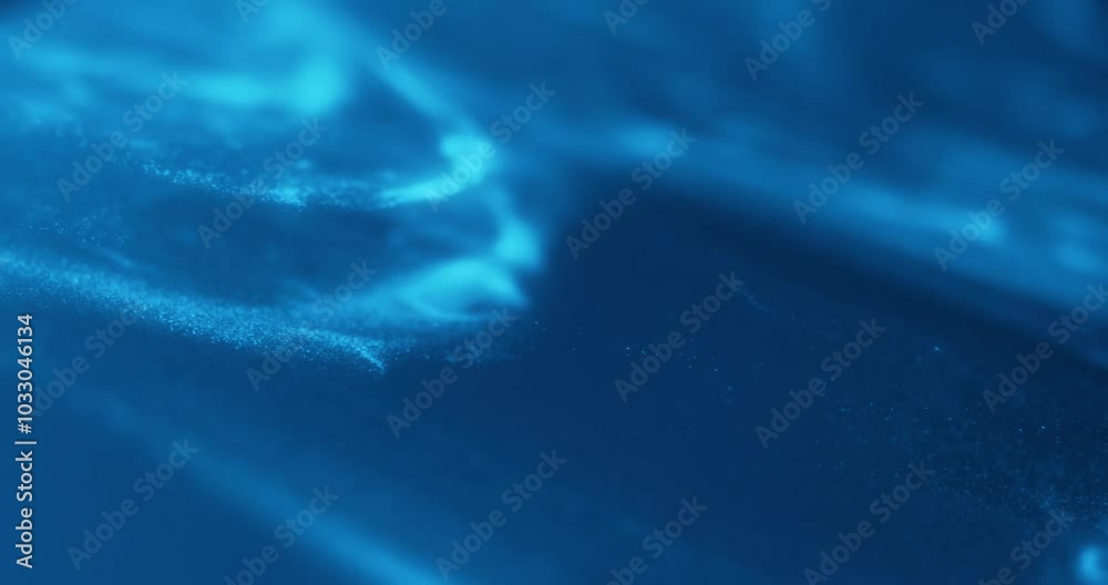 Blue abstract particle effect with flowing motion, resembling ...