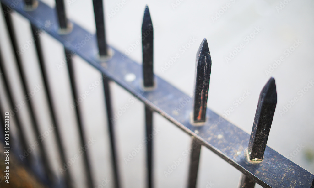 Close-up view of a metal fence with interlocking bars, symbolizing ...