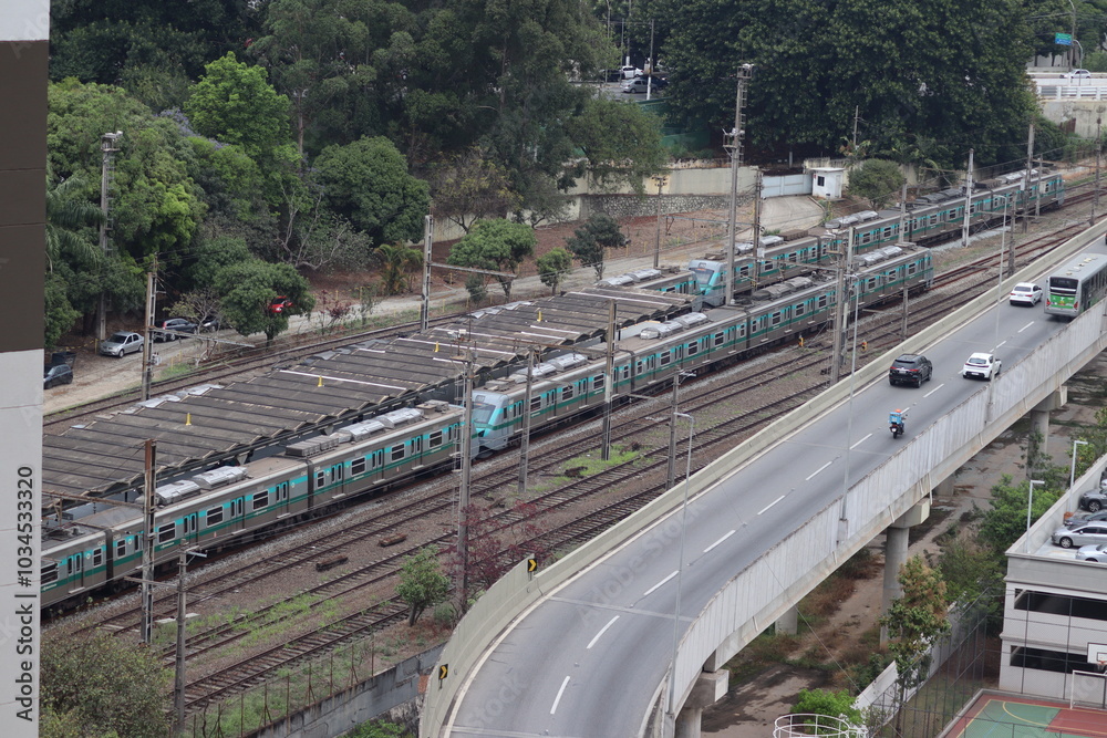 Modern green electric trains arriving and departing from a train ...