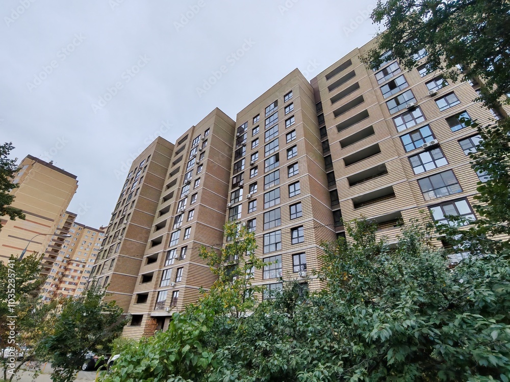 high-rise apartment building with light pastel colors and numerous ...