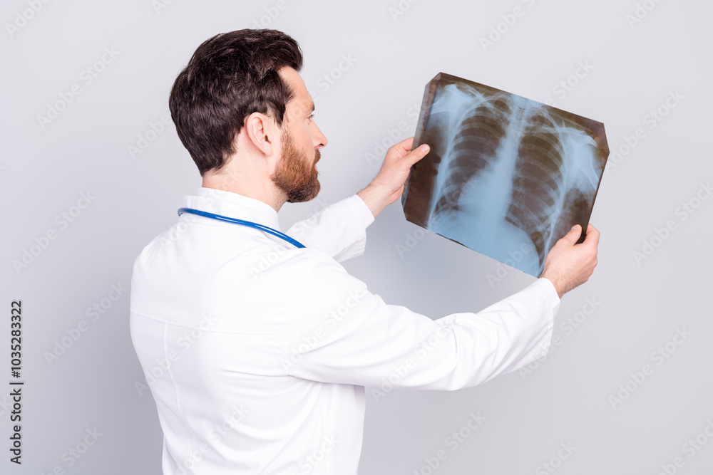 Photo of handsome doctor paramedic wear white coat watching xray scan ...