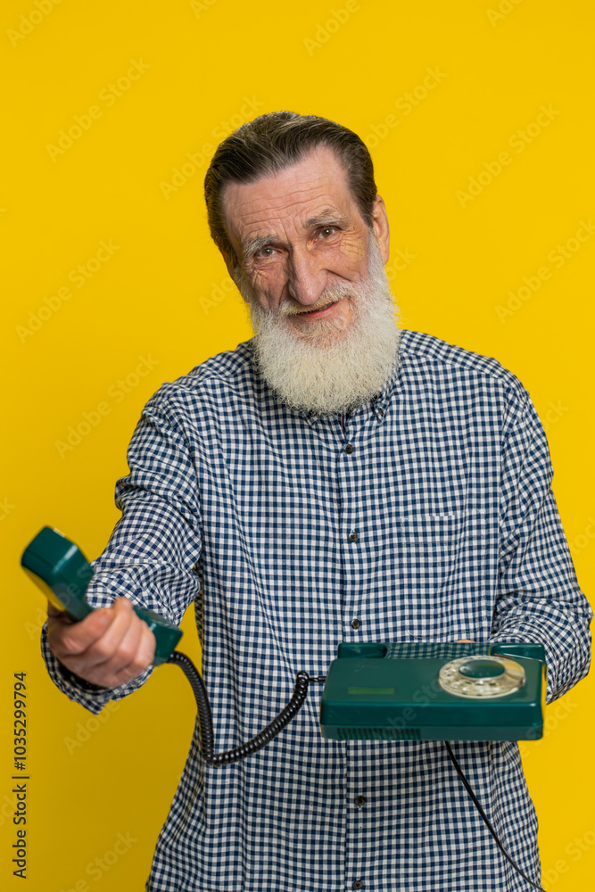 Hey you, call me back. Senior old man talking on wired landline vintage ...