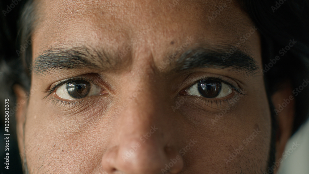 Extreme macro close-up view part male face brown eyes serious unhappy ...
