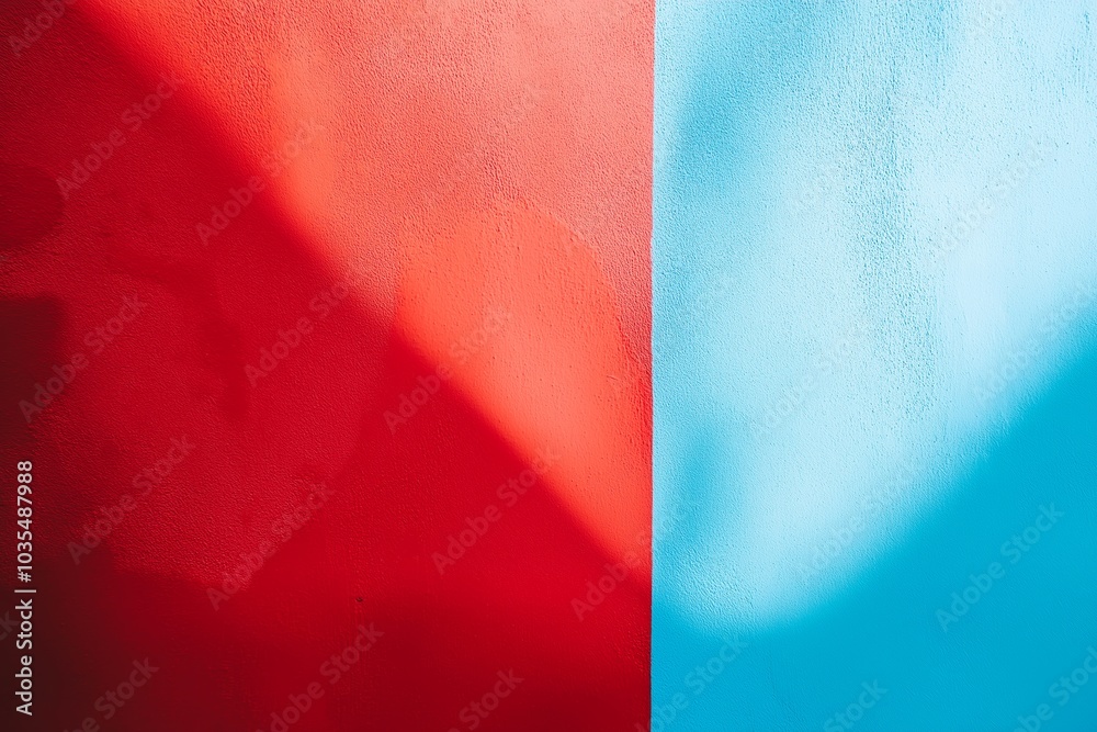 Brightly colored wall split between red and blue, with dramatic shadows ...